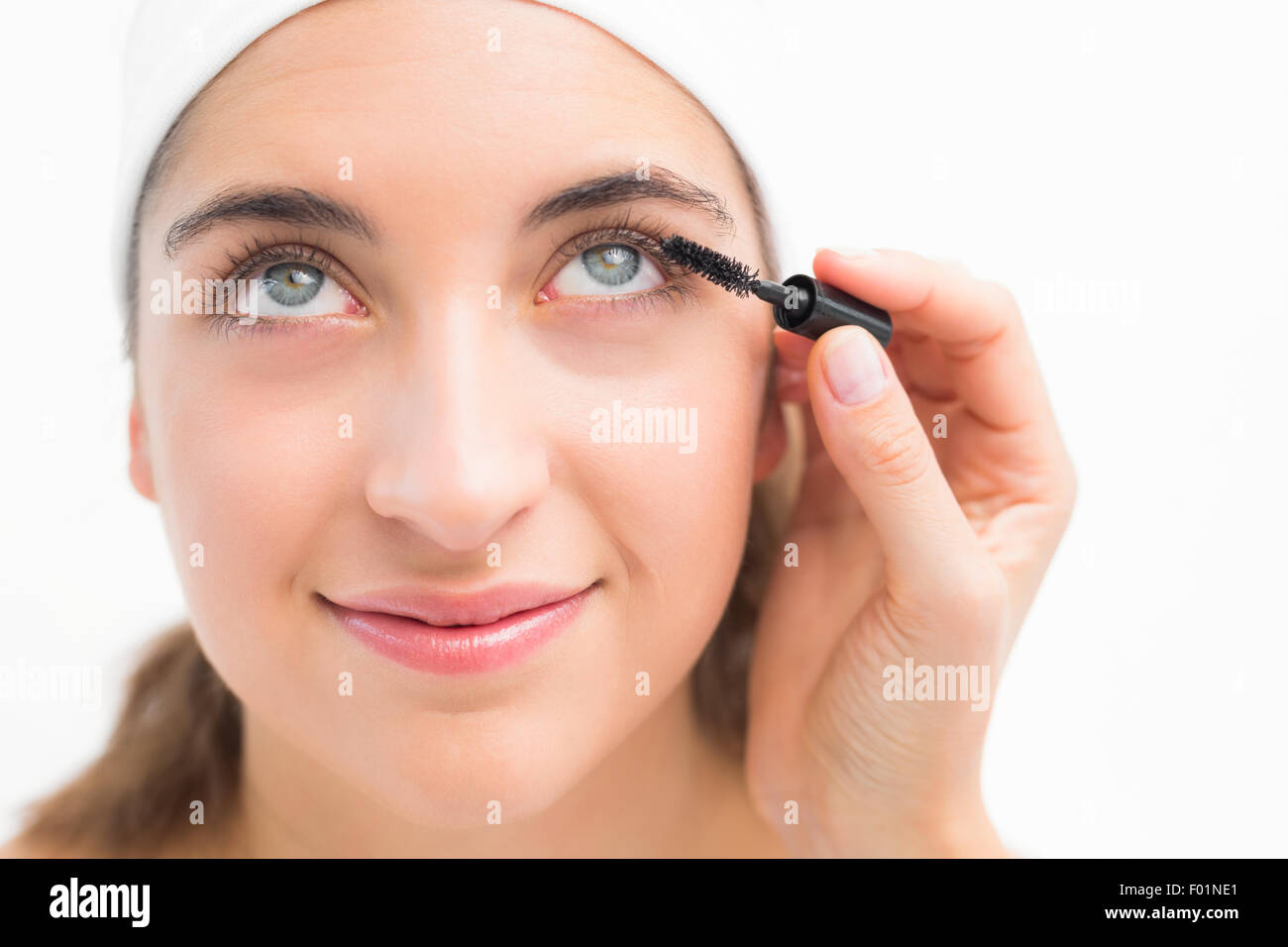 Hand applying mascara to beautiful woman Stock Photo - Alamy