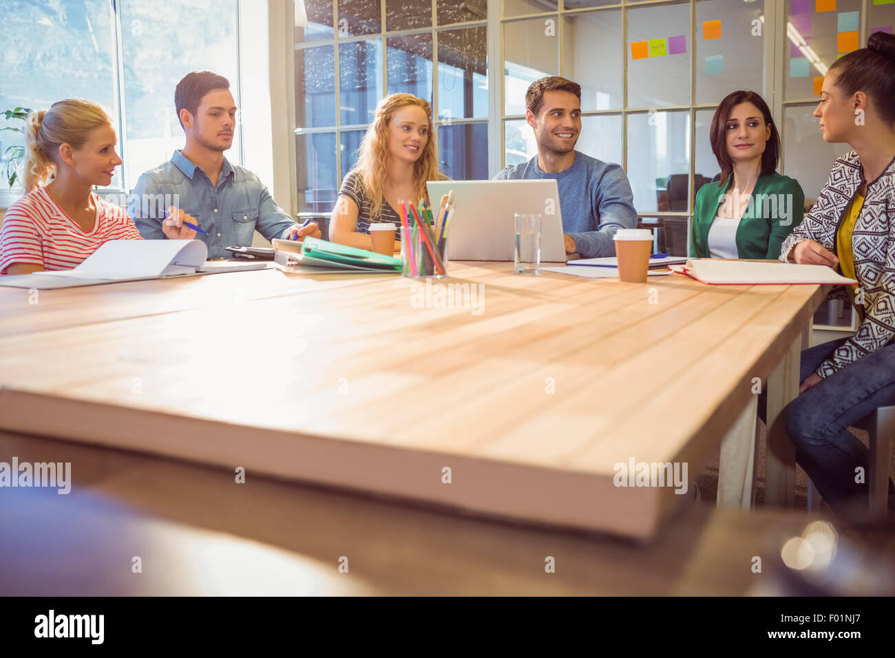 Group of young colleagues using laptop Stock Photo - Alamy