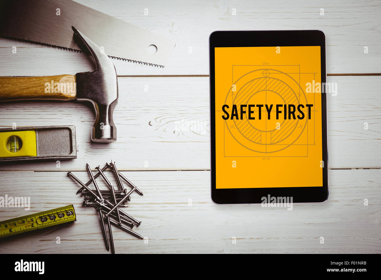 Safety first against blueprint Stock Photo - Alamy