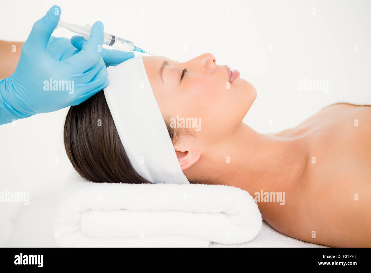 Woman receiving botox injection on her forehead Stock Photo - Alamy