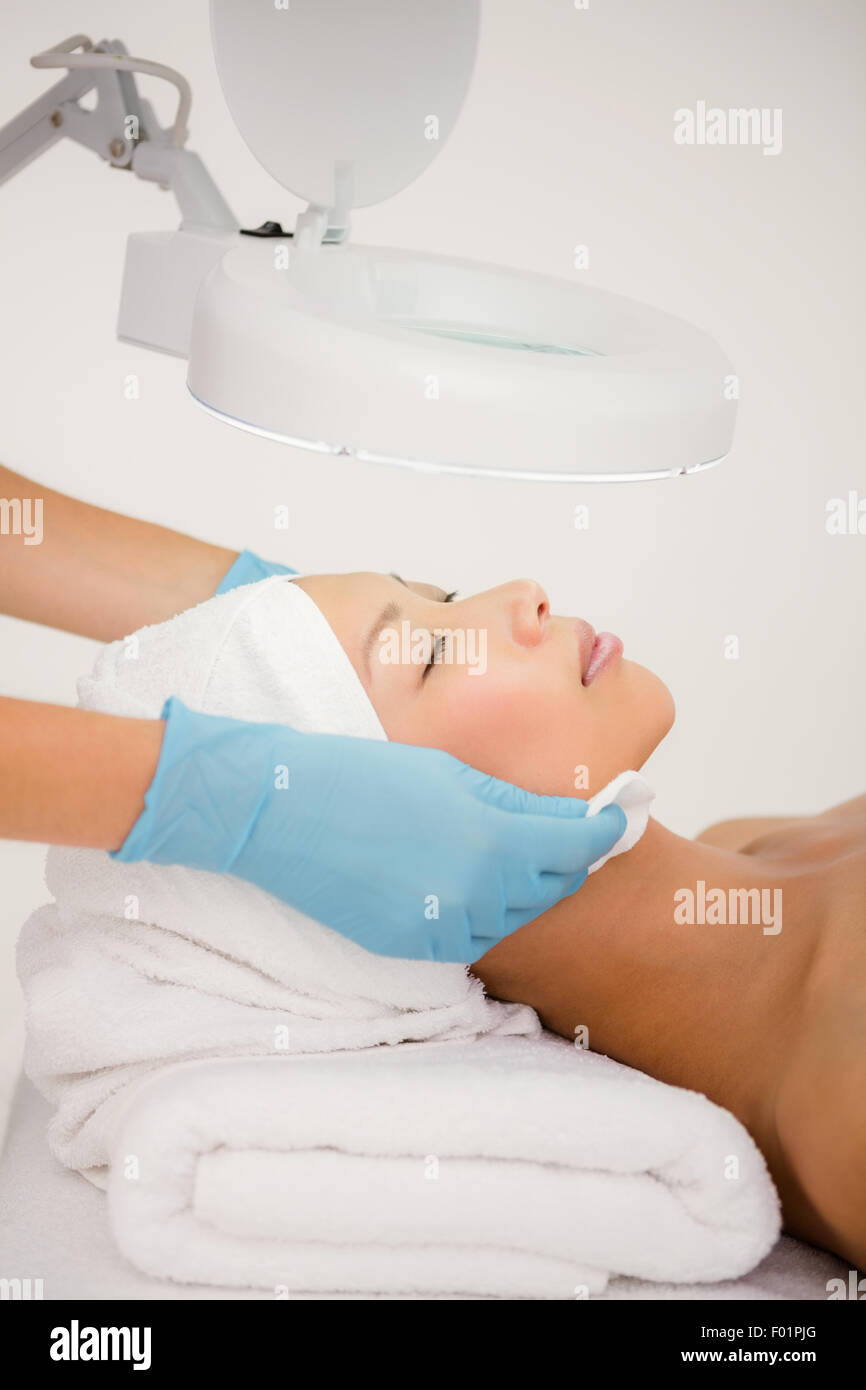 Hands cleaning woman face with cotton swabs Stock Photo - Alamy