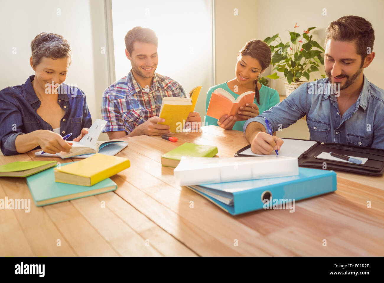 Group of colleagues reading books Stock Photo - Alamy