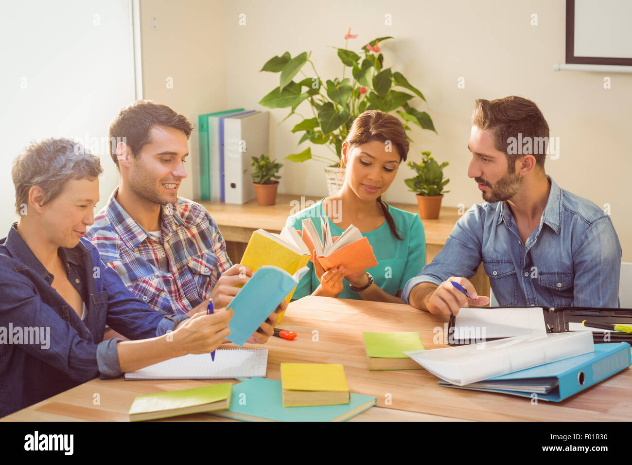 Group of colleagues reading books Stock Photo - Alamy