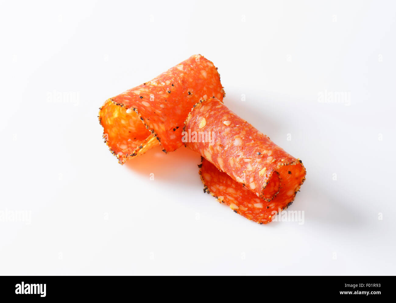 Black pepper-coated salami speckled with pieces of Comte cheese ...