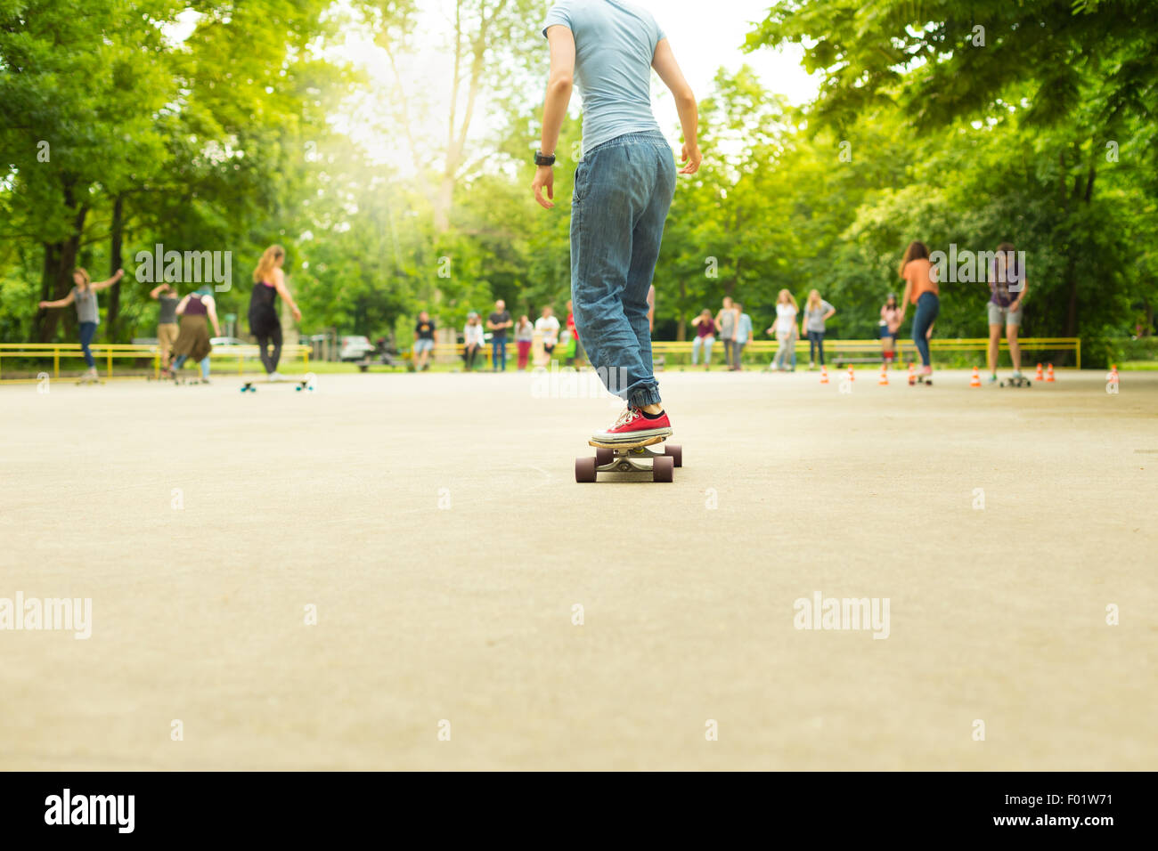 Girl practicing urban long board riding Stock Photo - Alamy