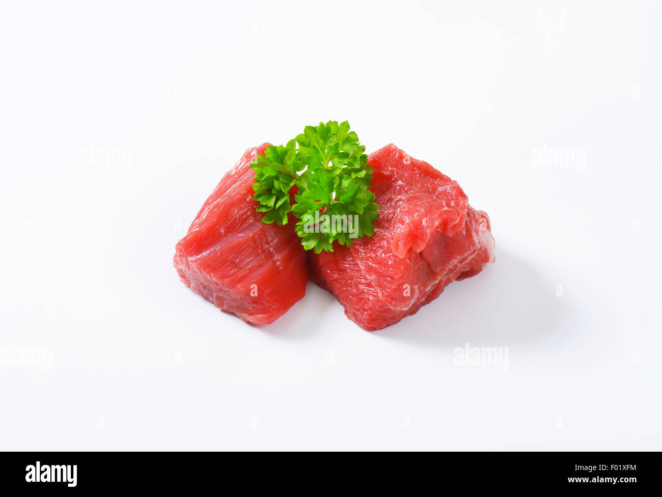 Raw beef cut into cubes Stock Photo - Alamy