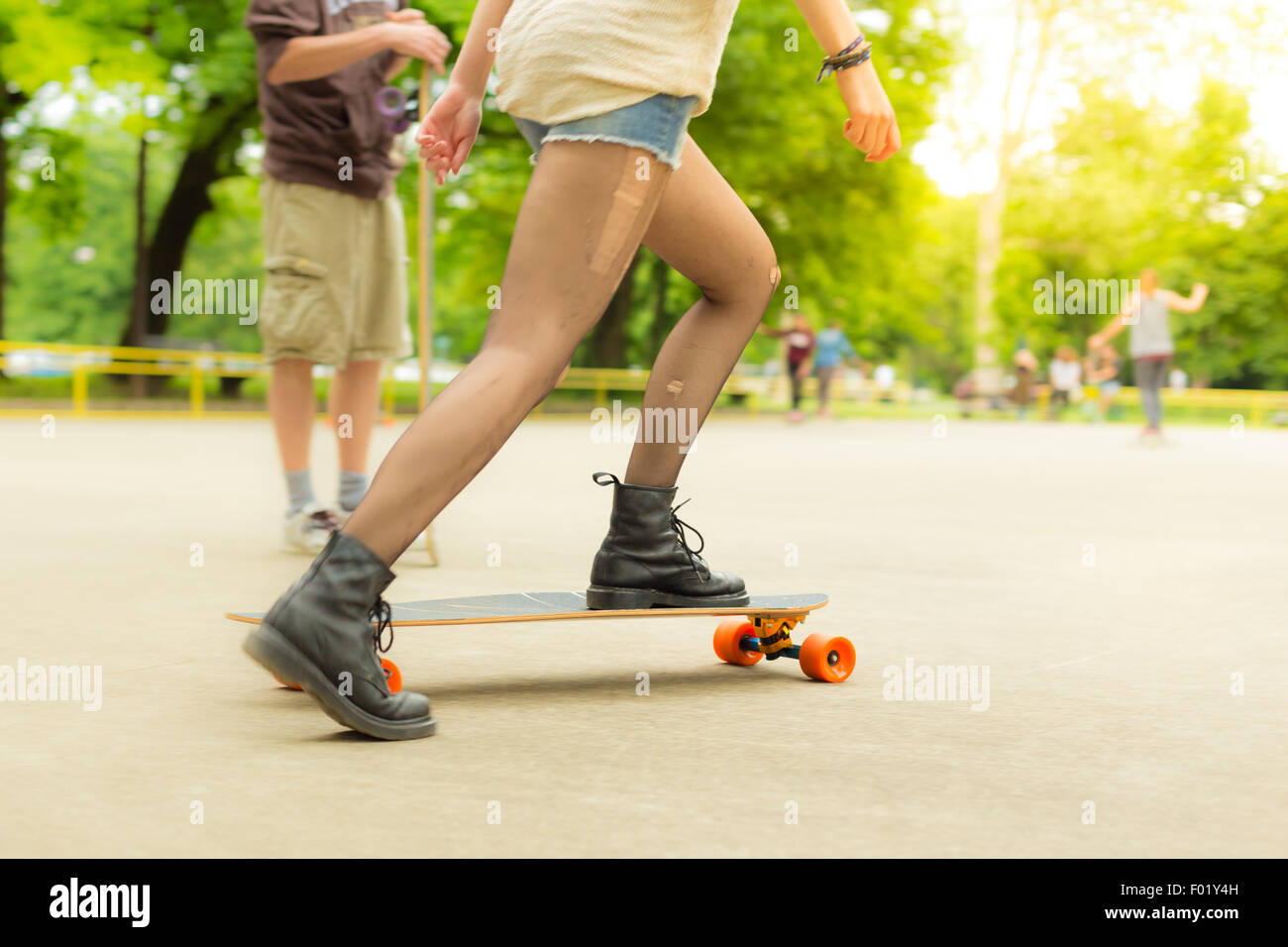 Teenage girl urban long board riding Stock Photo - Alamy