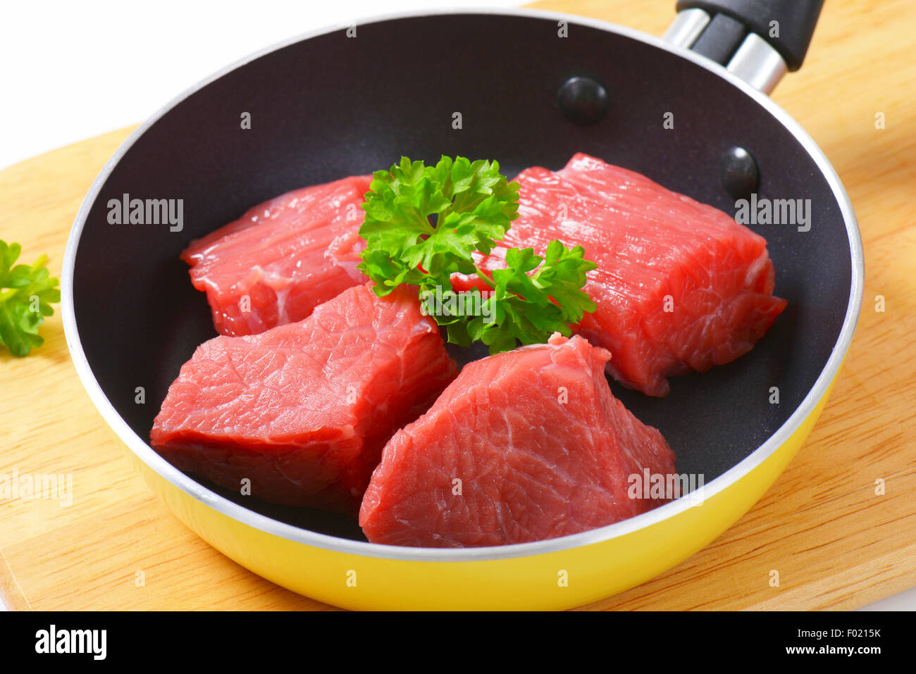 Raw diced beef in a pan Stock Photo - Alamy