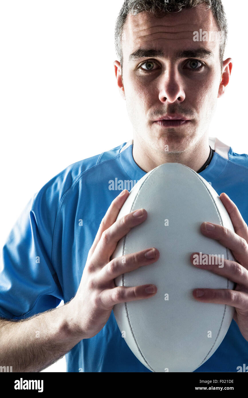 Rugby player holding a rugby ball Stock Photo - Alamy
