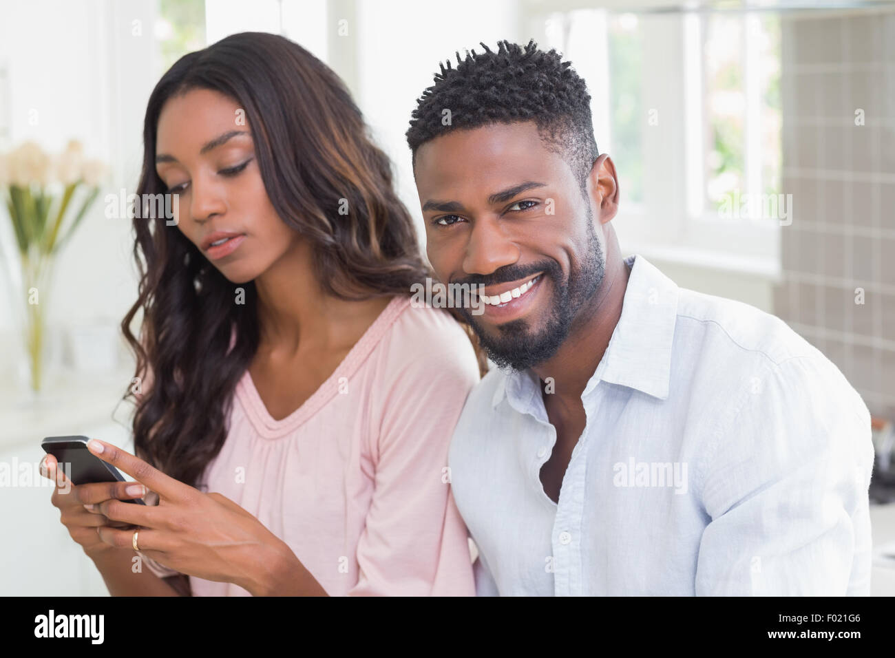 Happy couple using their phones at breakfast Stock Photo - Alamy