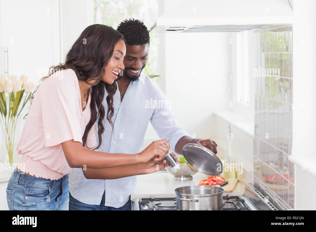 Happy couple cooking food together Stock Photo - Alamy