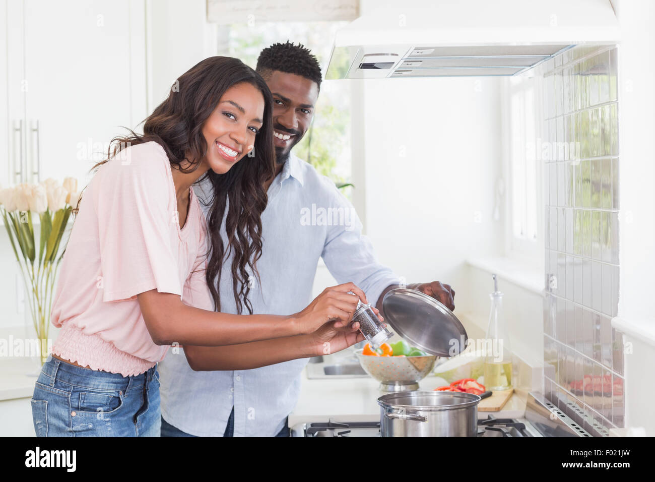 Happy couple cooking food together Stock Photo - Alamy