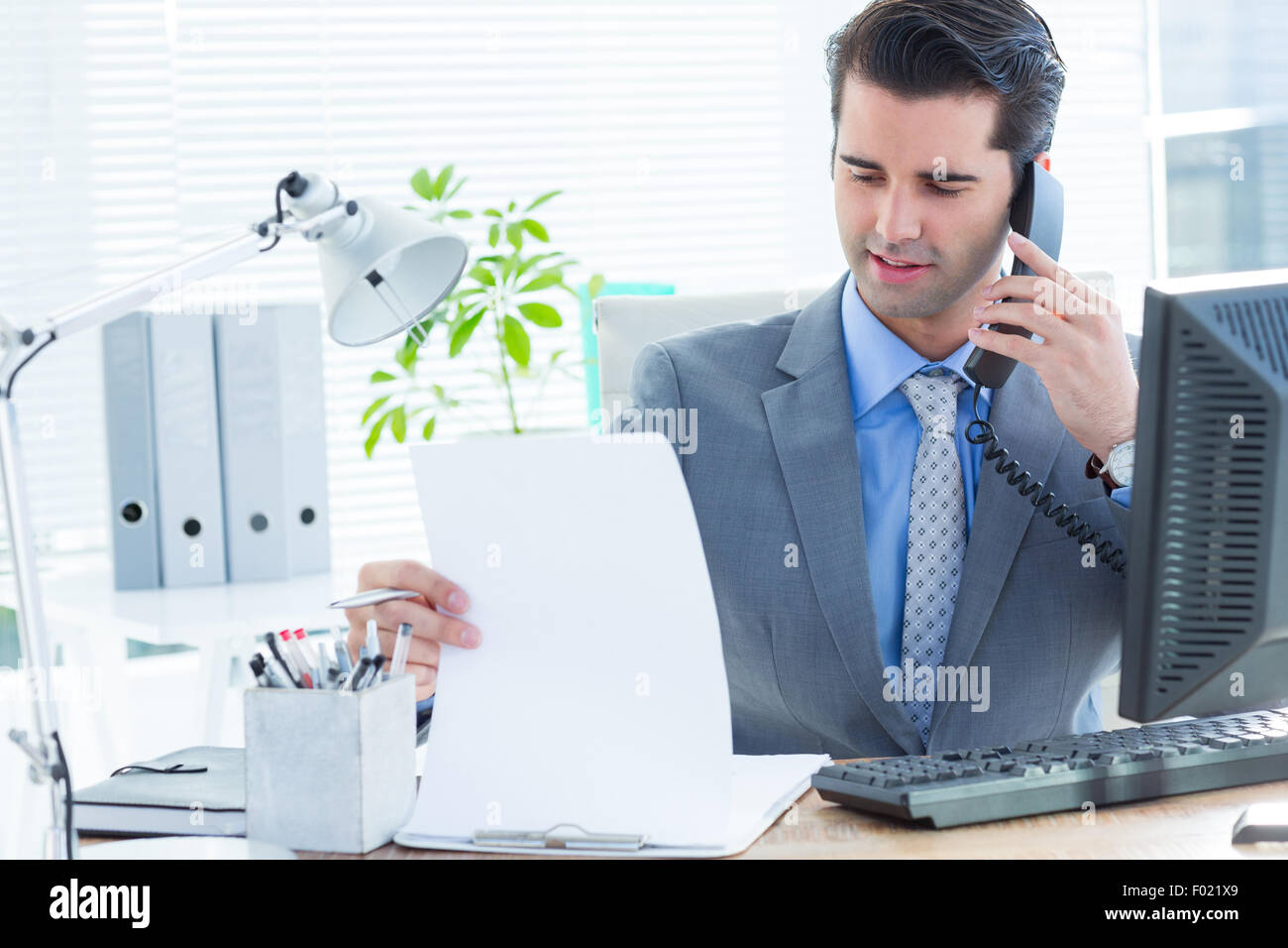 Professional businessman checking at his notebook Stock Photo - Alamy