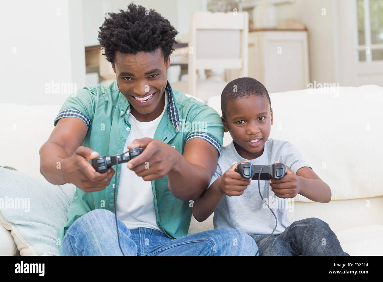 Father and son playing video games together Stock Photo - Alamy