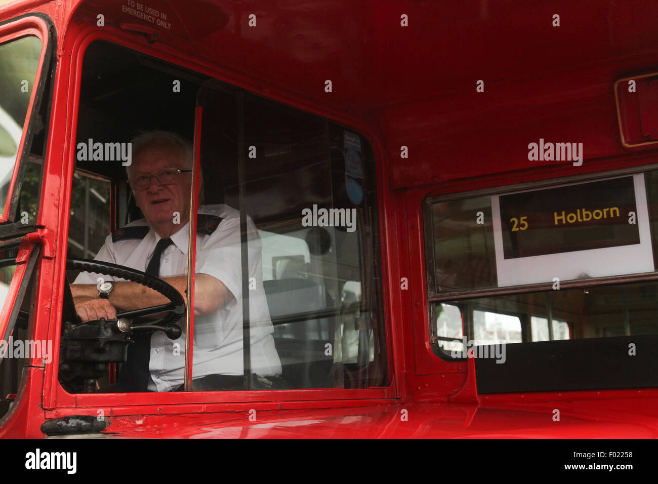 London, UK. 6 August, 2015. A route master bus driver on the queue at ...