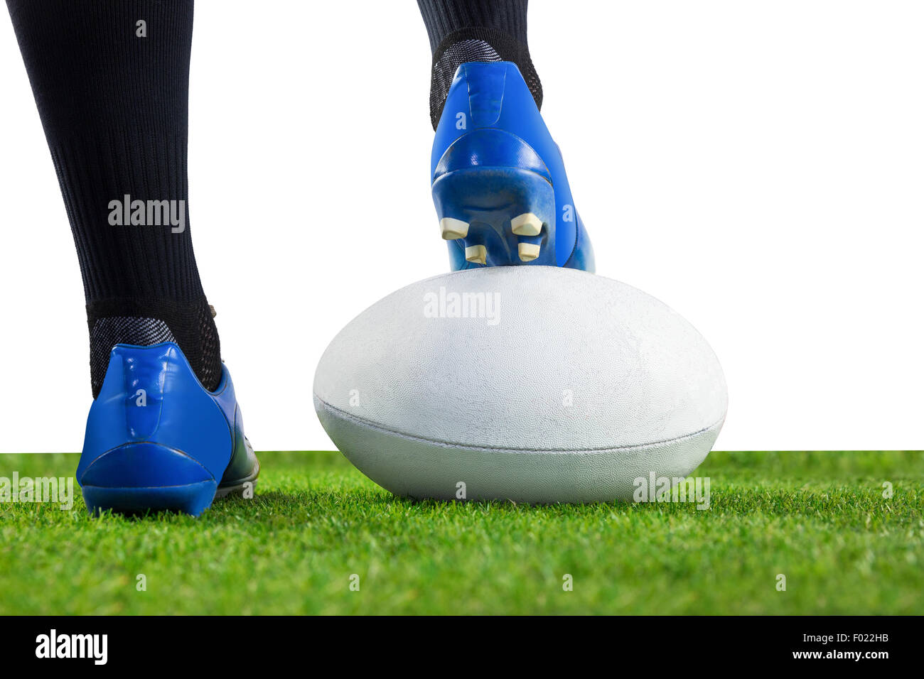 Rugby player posing feet on the ball Stock Photo - Alamy