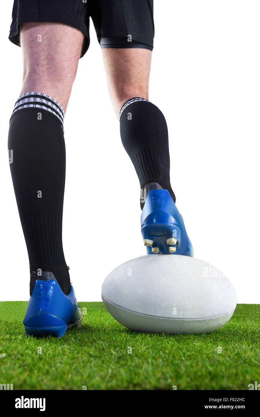 Rugby player posing feet on the ball Stock Photo - Alamy
