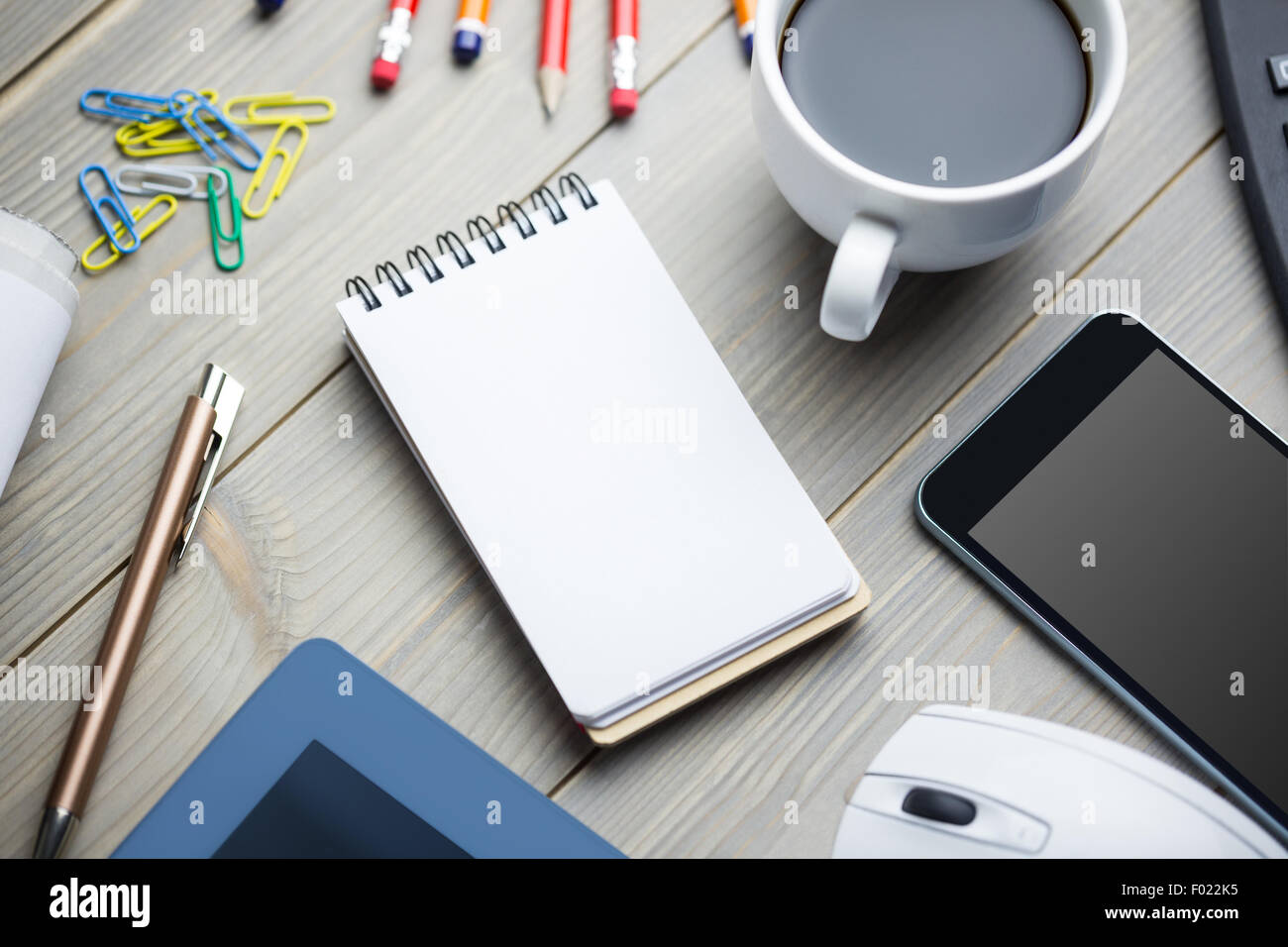 Notepad next to the cup of coffee smartphone mouse and tablet Stock ...