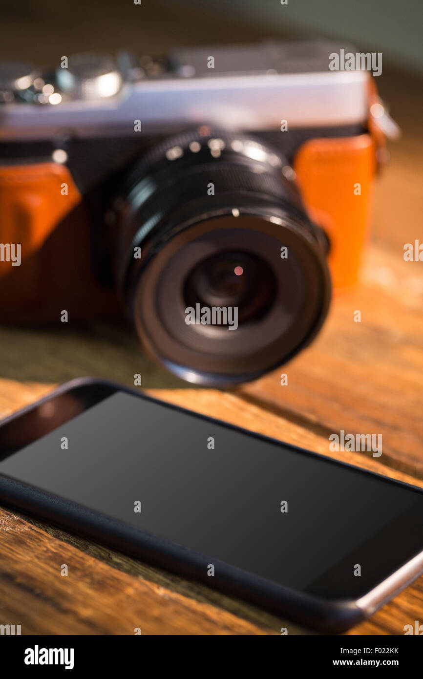 A beautiful brown fashioned camera next smartphone Stock Photo - Alamy
