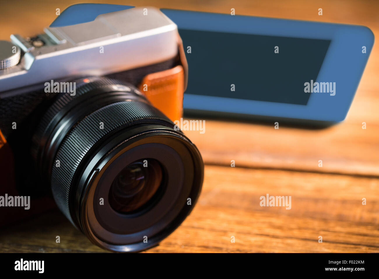 A beautiful brown fashioned camera next smartphone Stock Photo - Alamy