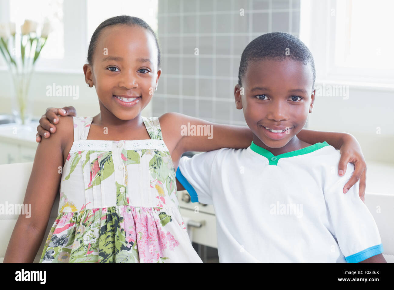 Happy siblings smiling at camera Stock Photo - Alamy
