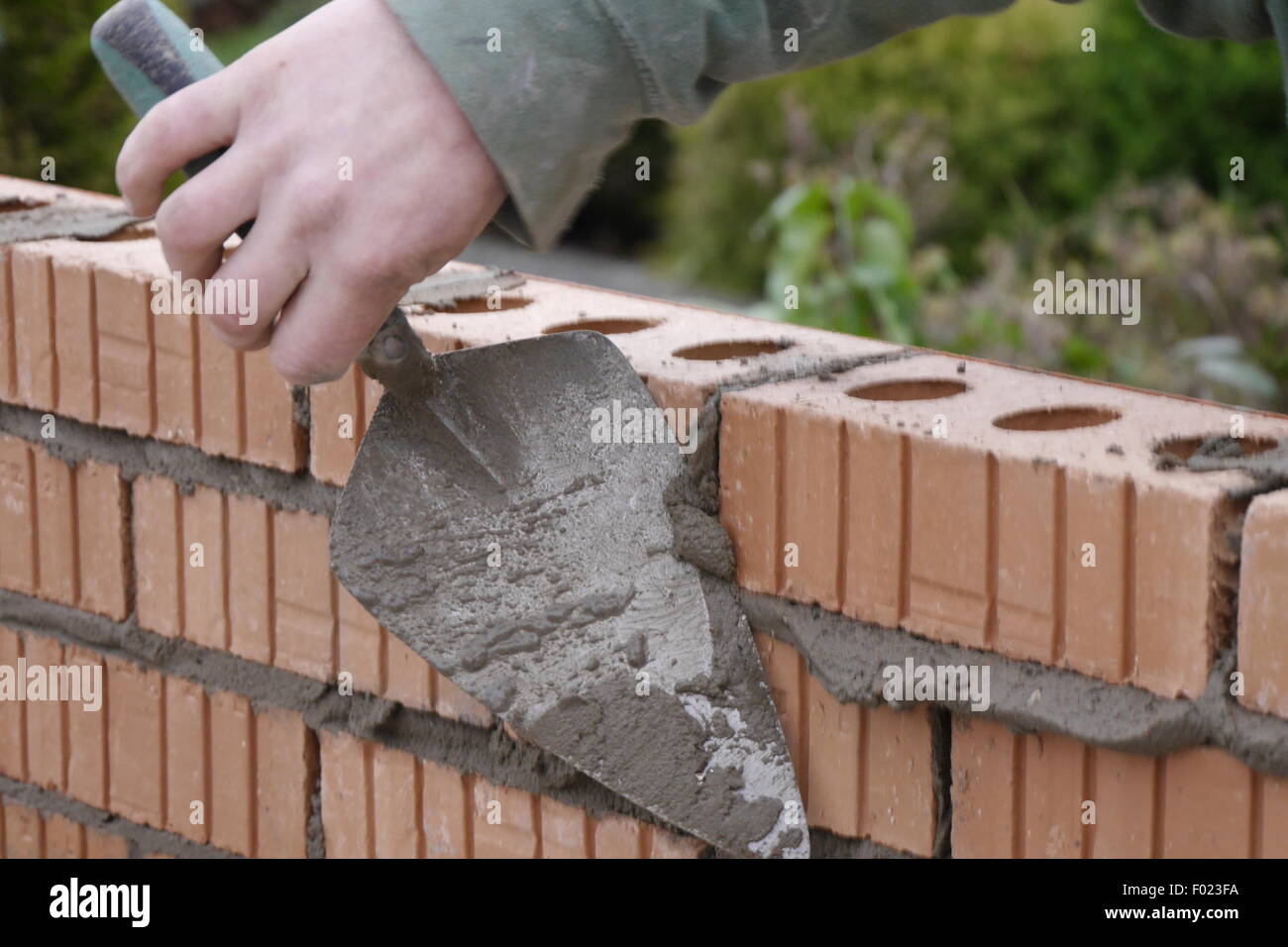 Closeup of bricklayer building a wall Stock Photo - Alamy