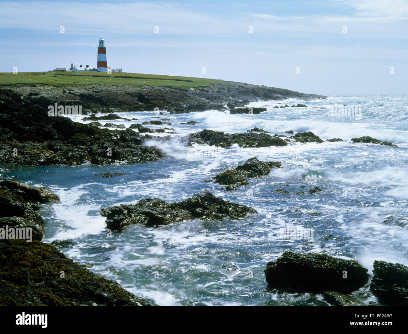 Bardsey Island lighthouse, Gwynedd, looking SSW along rocky coastline ...