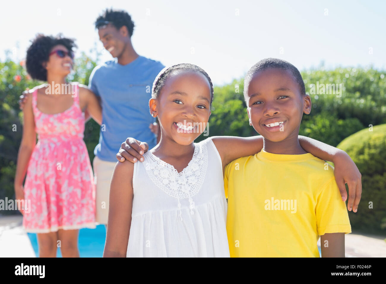 Happy siblings smiling at camera Stock Photo - Alamy