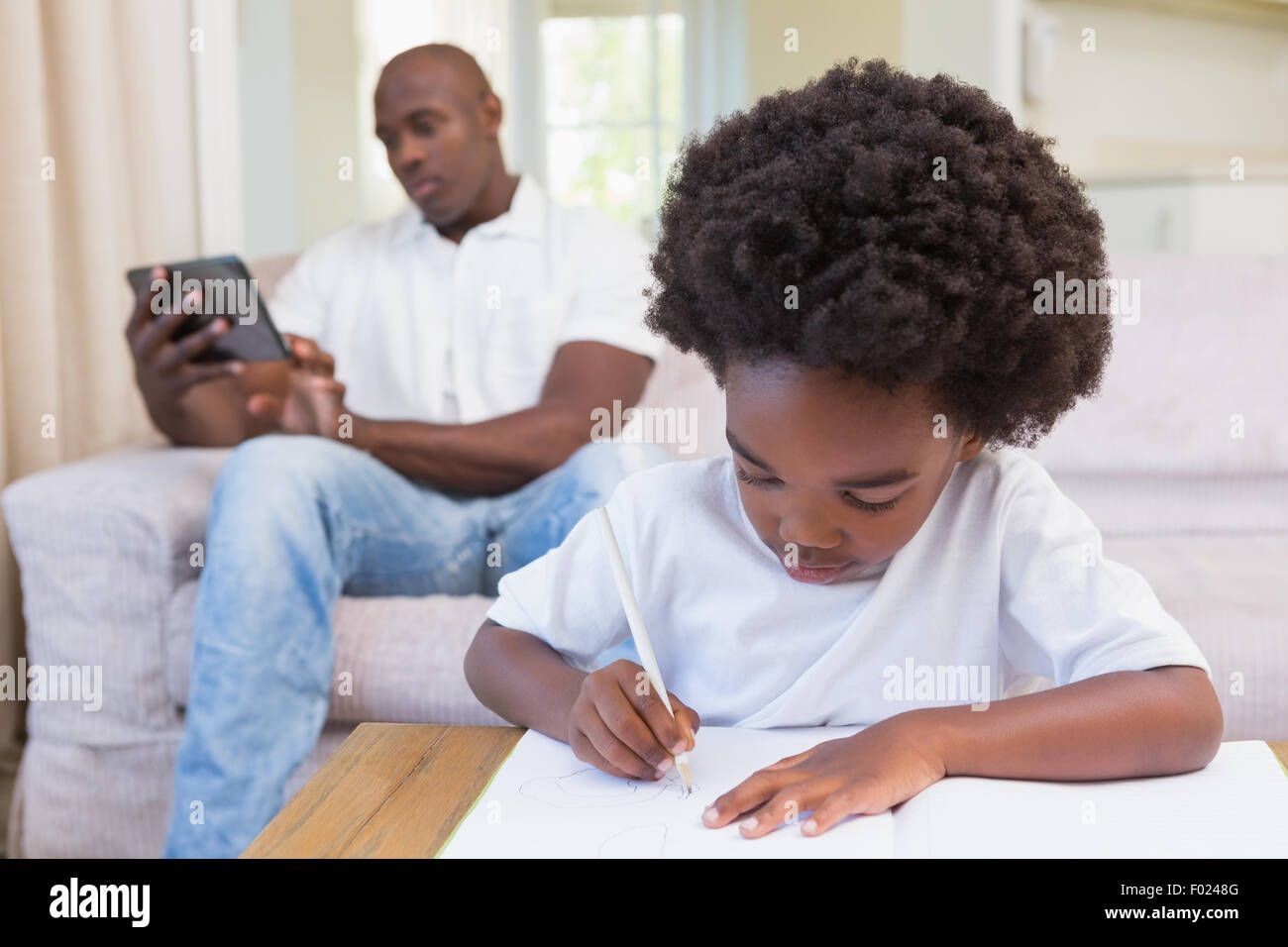 A little boy writing on notepad Stock Photo - Alamy