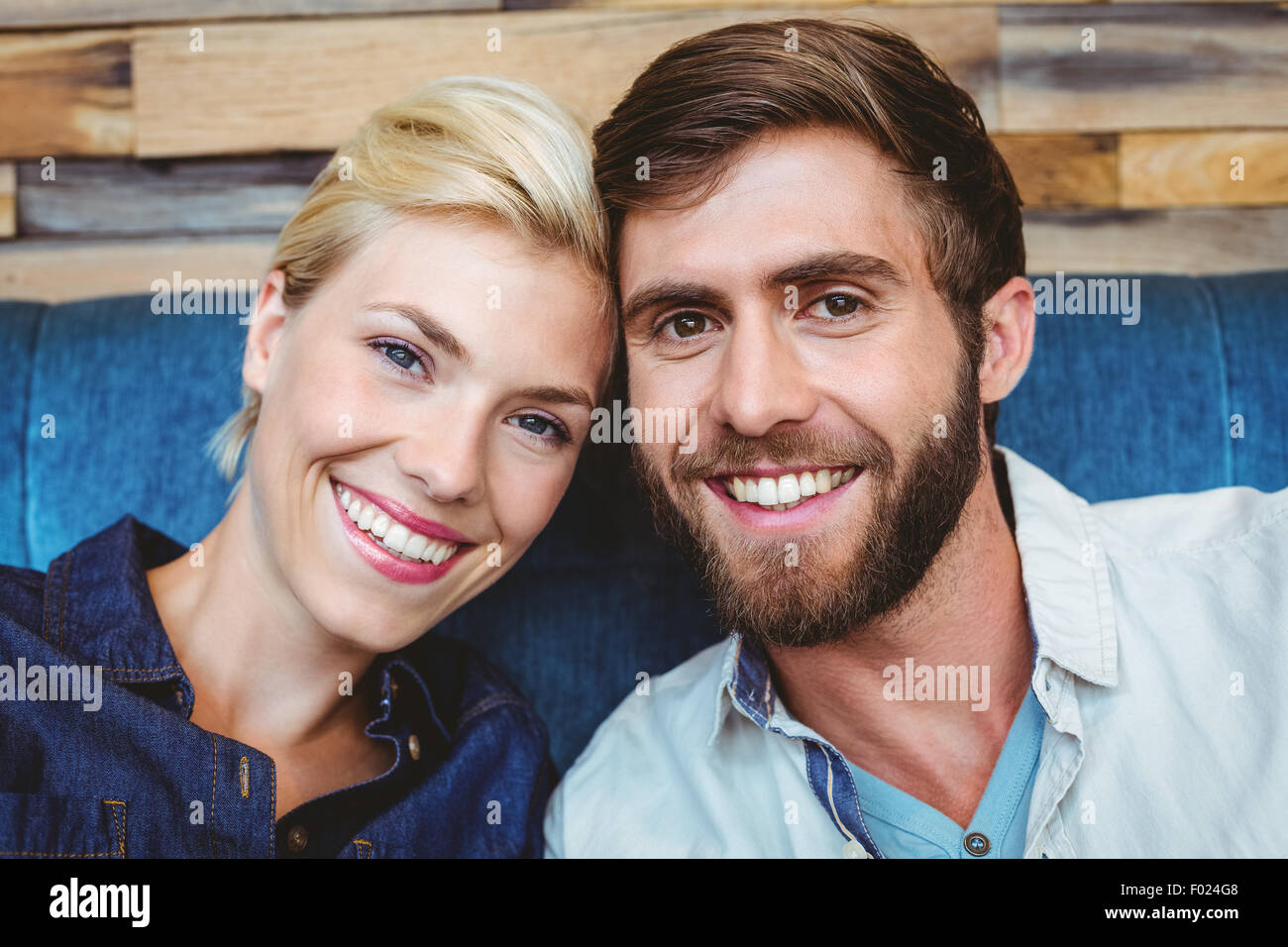 Cute couple on a date smiling at the camera Stock Photo - Alamy