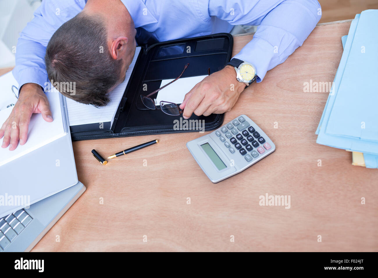 Exhausted businessman sleeping on the desk Stock Photo - Alamy