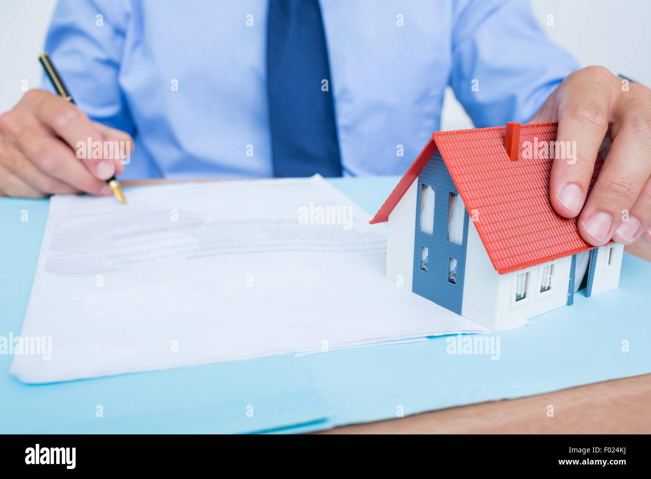 Businessman reading and writing a contrat before signing it Stock Photo ...
