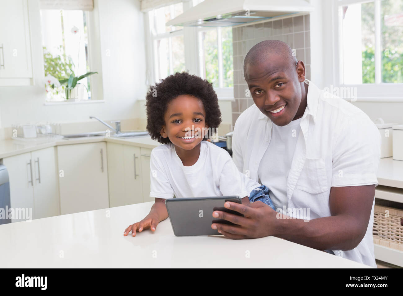 Portrait of a father and son using digital tablet Stock Photo - Alamy