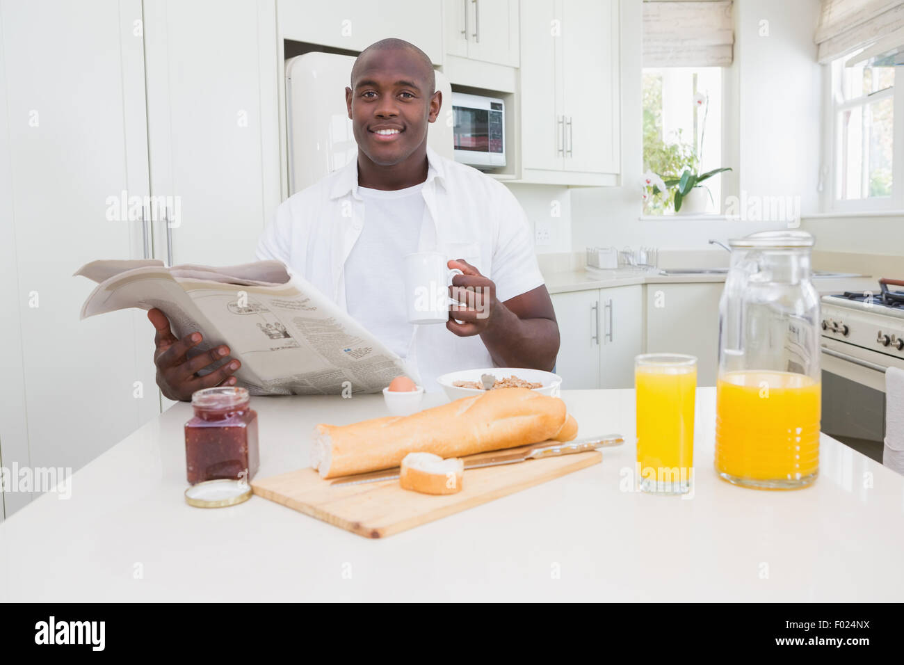 Smiling man taking his breakfast Stock Photo - Alamy