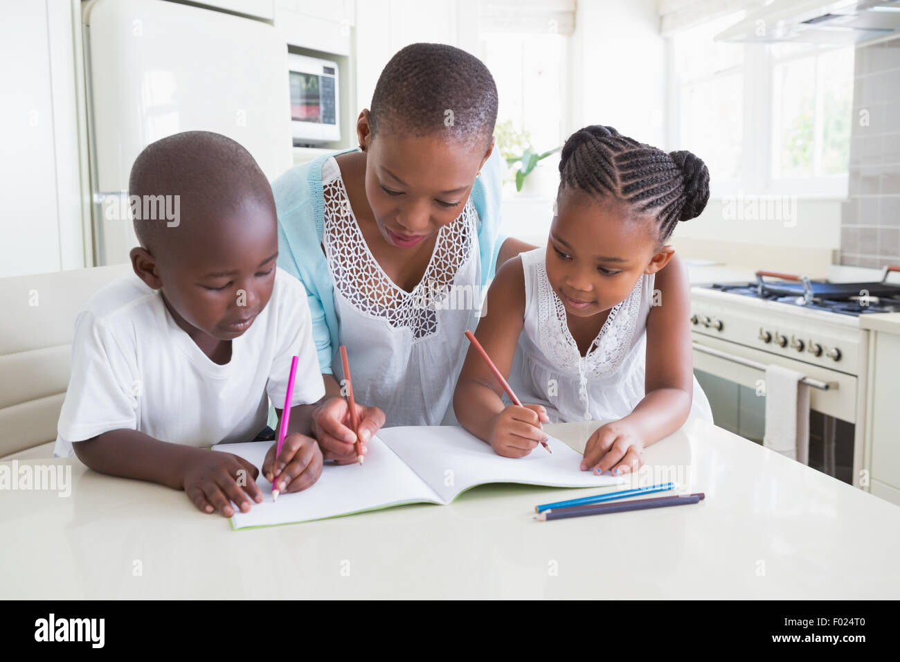 Happy family working on the table Stock Photo - Alamy