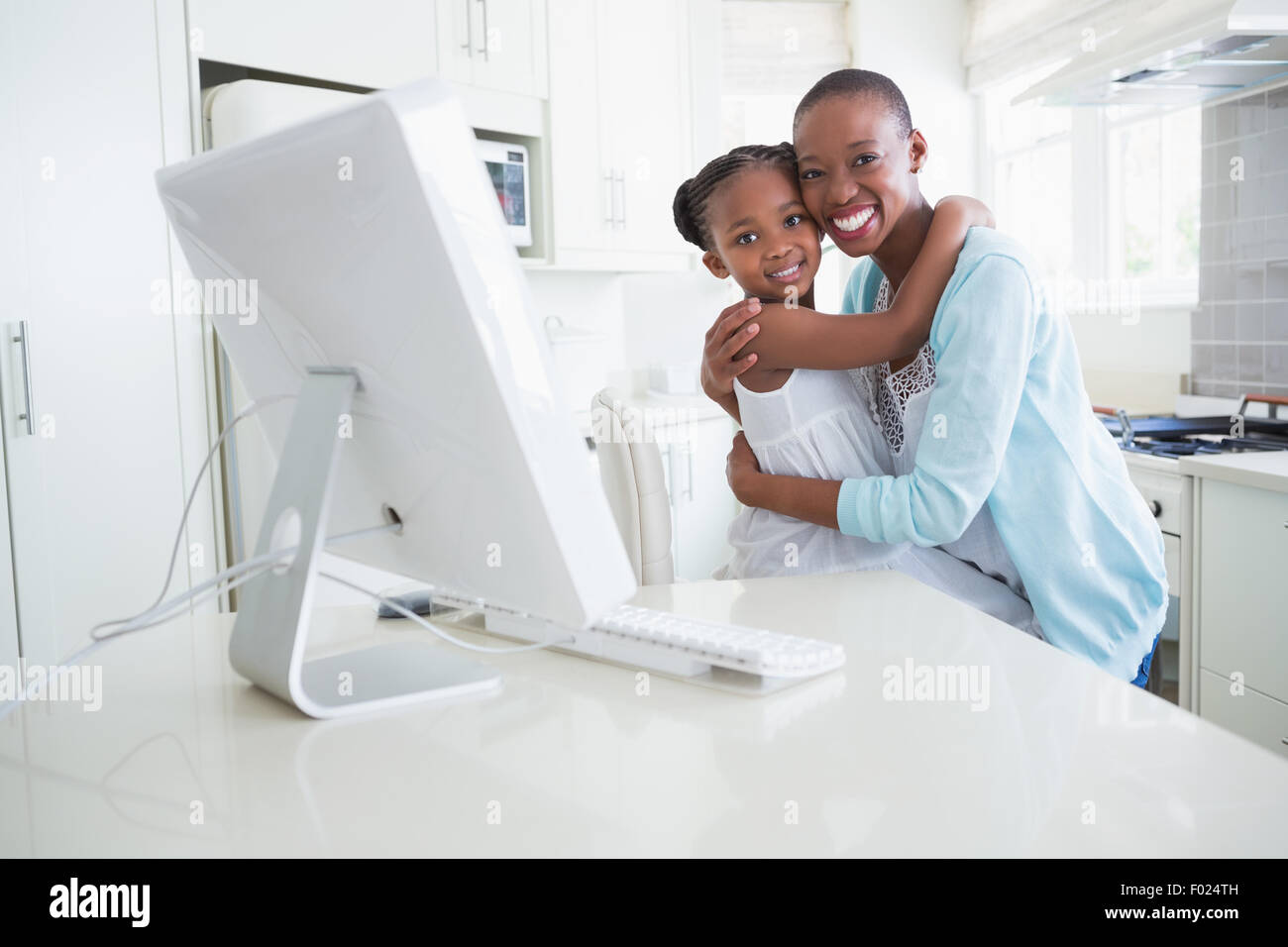 Happy smiling mother with her daughter using computer Stock Photo - Alamy