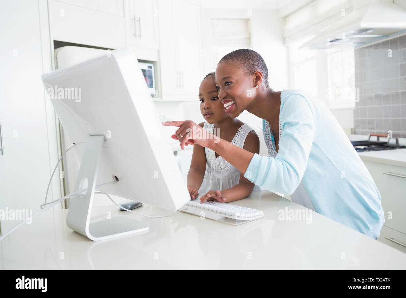 Happy smiling mother with her daughter using computer Stock Photo - Alamy