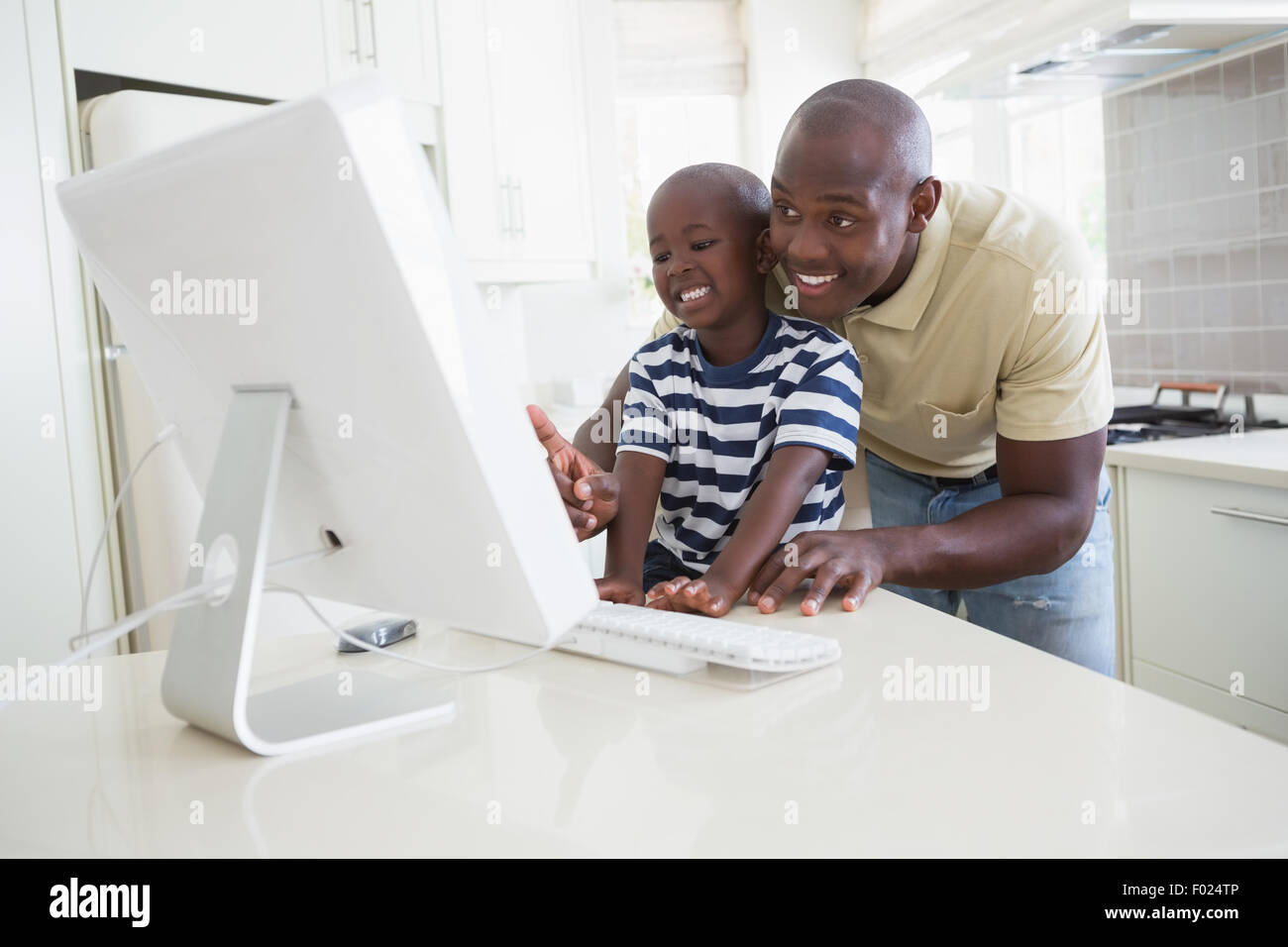 Happy smiling father with his son using computer Stock Photo - Alamy