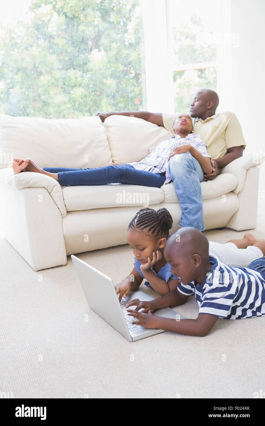 Happy siblings using their laptop Stock Photo - Alamy