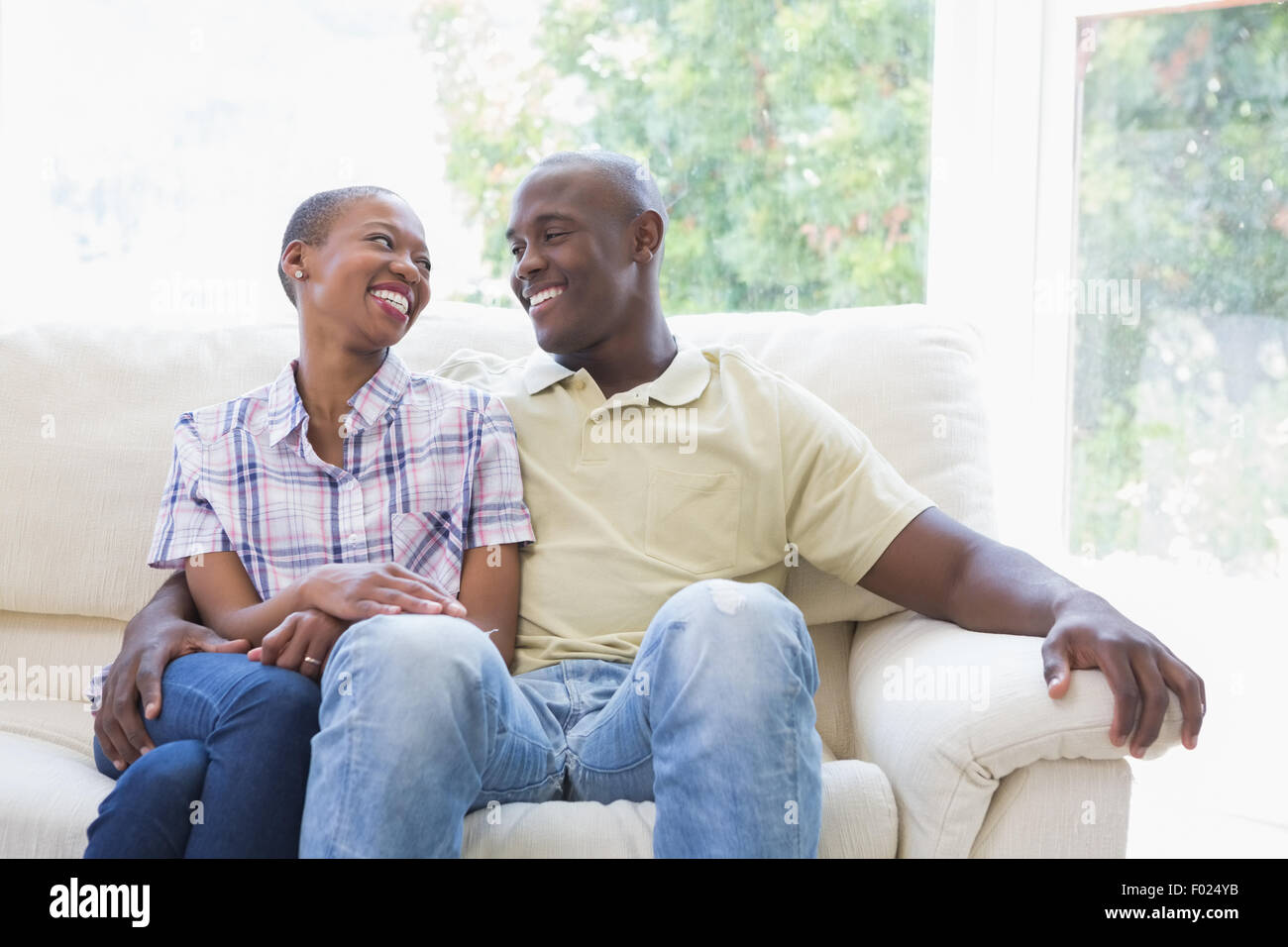 Happy smiling couple on the couch Stock Photo - Alamy