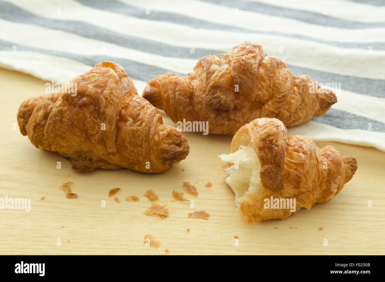 Three croissant on wood board Stock Photo - Alamy