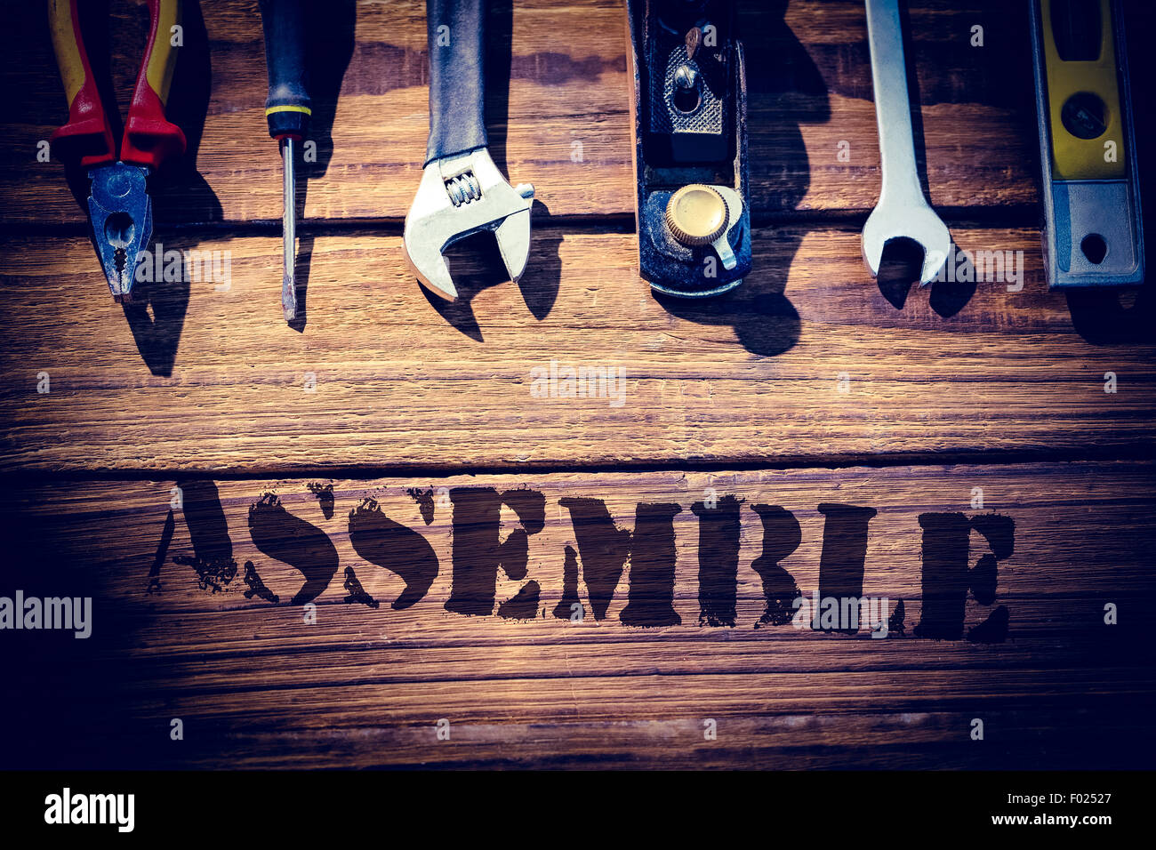 Assemble against desk with tools Stock Photo - Alamy