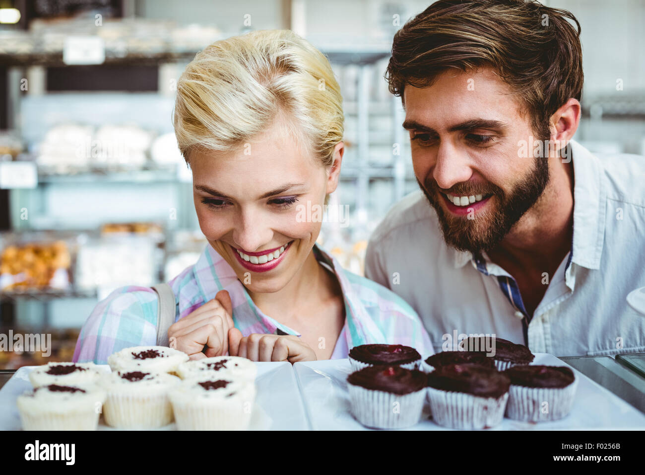 Cute couple on a date looking at cakes Stock Photo - Alamy