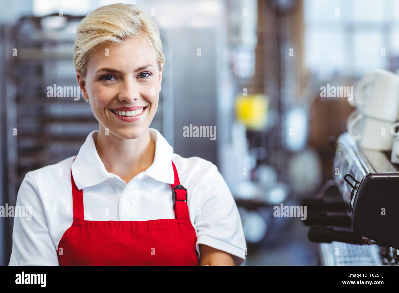 Pretty barista smiling at the camera Stock Photo - Alamy