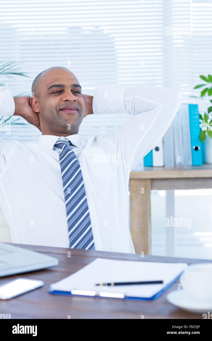Relaxed businessman lying down in swivel chair Stock Photo - Alamy