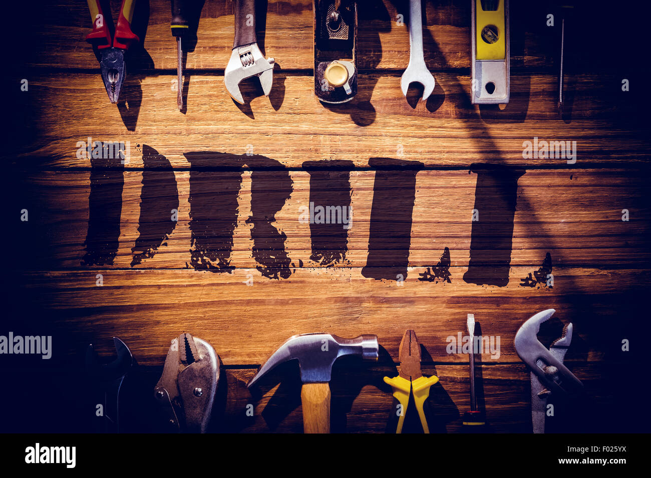 Drill against desk with tools Stock Photo - Alamy