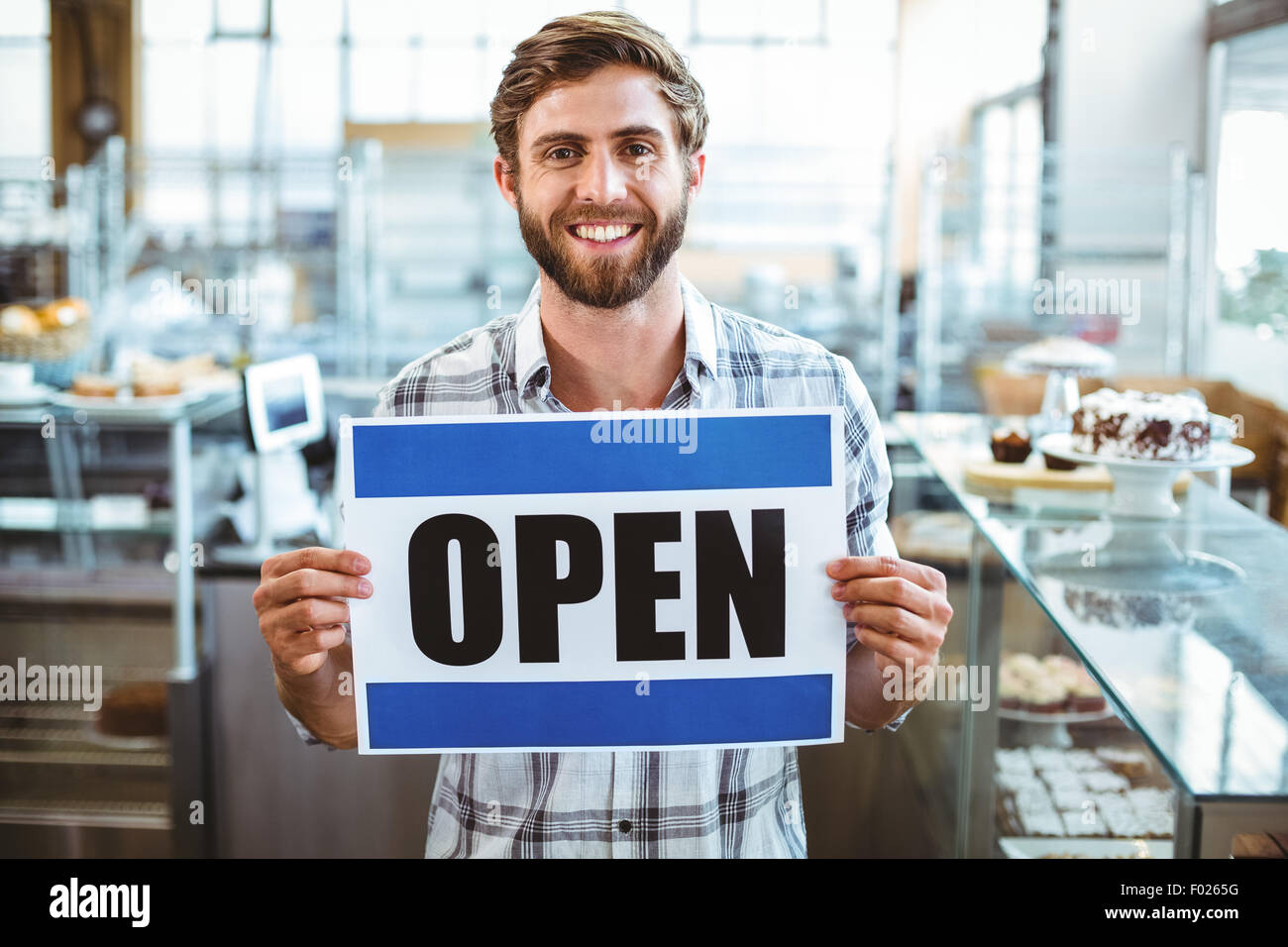 Cafe owner smiling at the camera Stock Photo - Alamy