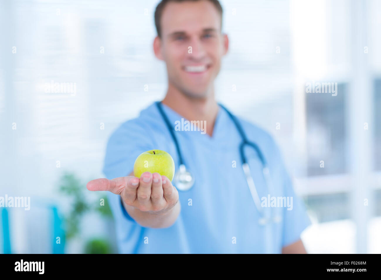 Doctor holding red apple hi-res stock photography and images - Alamy
