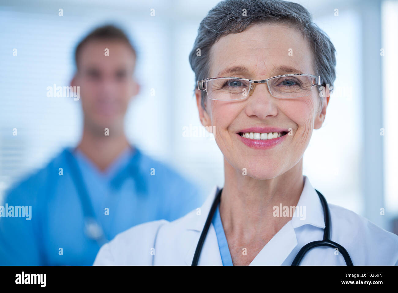 Smiling colleagues doctors looking at the camera Stock Photo - Alamy