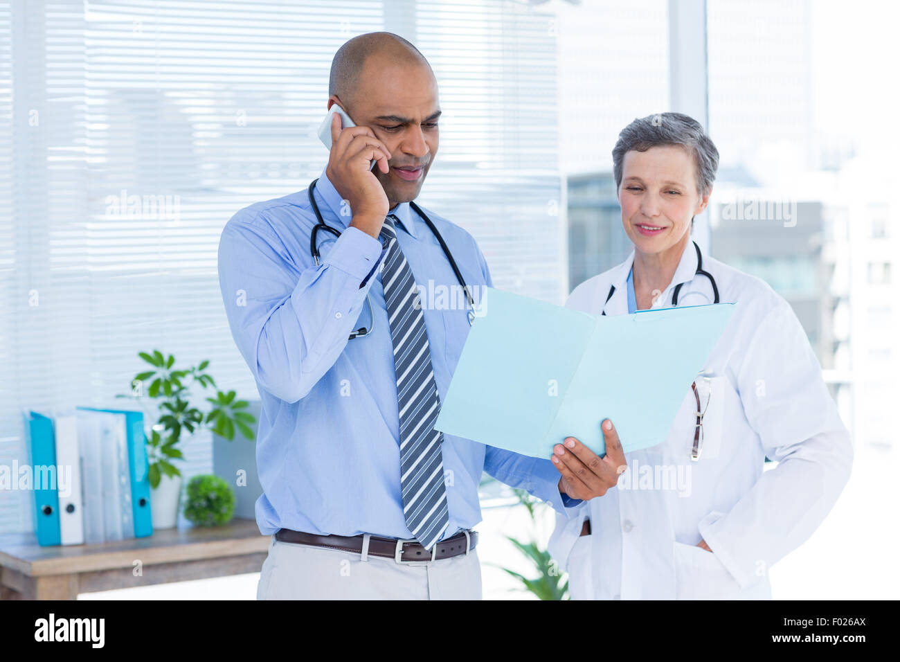 Doctor calling patient hi-res stock photography and images - Alamy